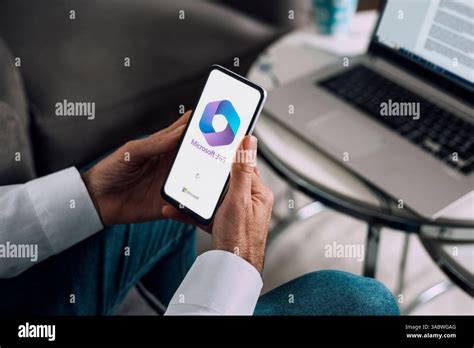 Man Using A Mobile Phone Displaying Logo Of Microsoft Office 365 On The Screen Rosario