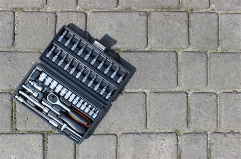 Premium Photo A Set Of Repairing Tools In A Plastic Case On A Concrete Paving Slabs
