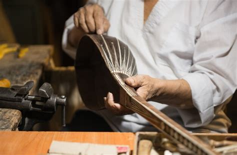Premium Photo Adult Master Restores Old Musical Instruments Production Of Stringed Instruments