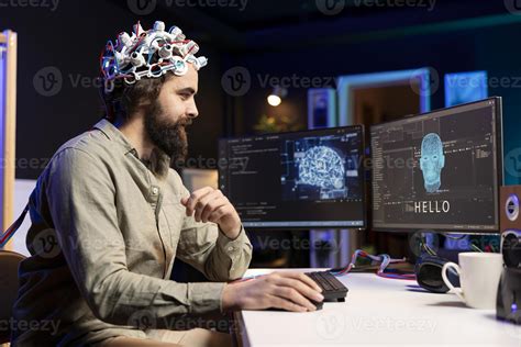 Man Using EEG Headset To Communicate With Artificial Intelligence On Computer In Binary Code