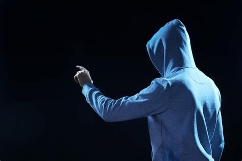 Premium Photo Hacker Pushing Button On Virtual Screen Against Dark