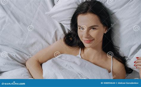 Portrait Of Beautiful Young Brunette Charmingly Laying In Her Bed And