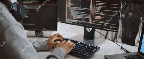 Young Adult Asian Male Software Developer Coding Program On Desktop Computer Man Work From Home