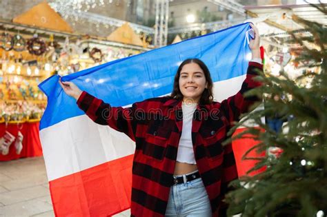 Cheerful Girl With Flag Of Netherlands At Christmas City Market Stock