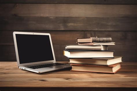 Premium Photo Stack Of Books With Laptop On Wooden Table