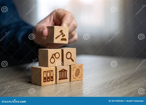 A Man Assembles A Judicial System From Blocks In The Shape Of A Pyramid