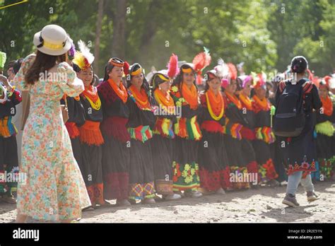 A Tourist Looking At The Kalash Women Dancing At The Chilam Joshi