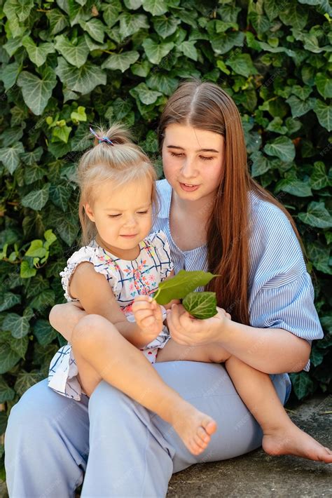 Joyful Older Sister Holding Younger Sister Playing And Laughing Having