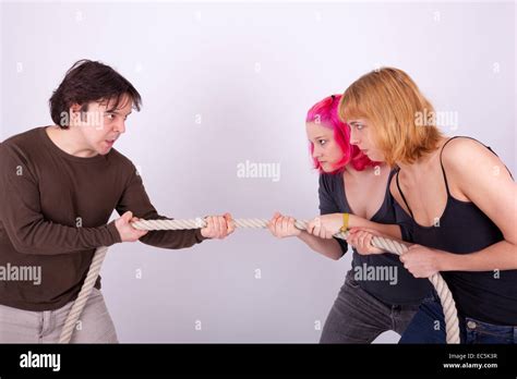 Two Women And A Man Are Pulling A Rope Stock Photo Alamy