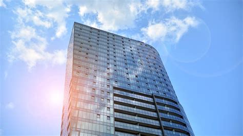 Glass And Steel Mirrored Facade Of Modern Office Building With Blue Sky Stock Image Image Of