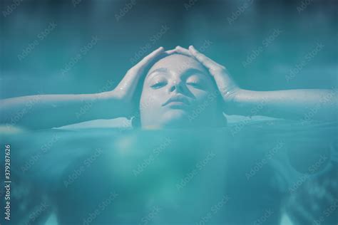 Natural Beauty Of Beautiful Girl In Pool Model Relaxing In Water At