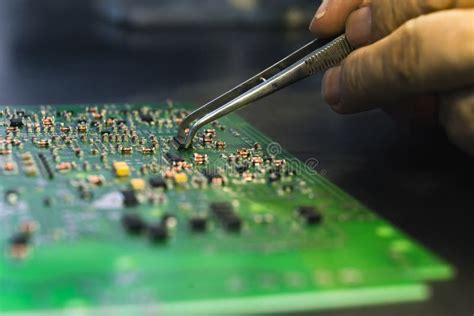 Close Up Shot Of Pcb Printed Circuit Board With Mounted Electrical Components And Hand With