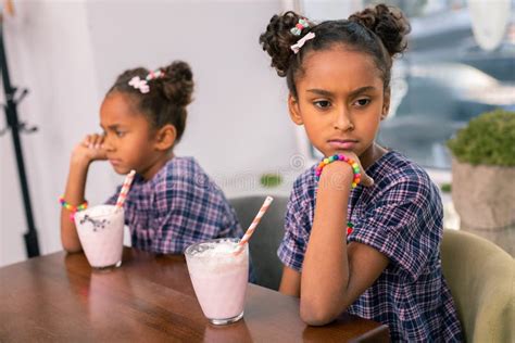 Dark Eyed Curly Sister Feeling Angry After Arguing With Her Little