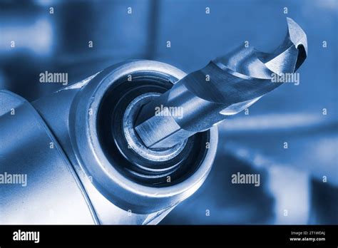 Sharp Drill Bit Clamped In Machine Chuck With Right Angle Head In Blue