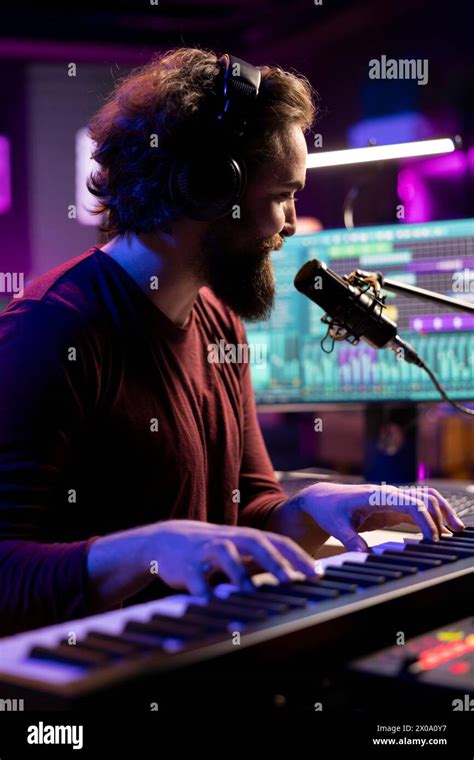Sound Engineer Playing Piano Keyboard To Compose New Music Singing On