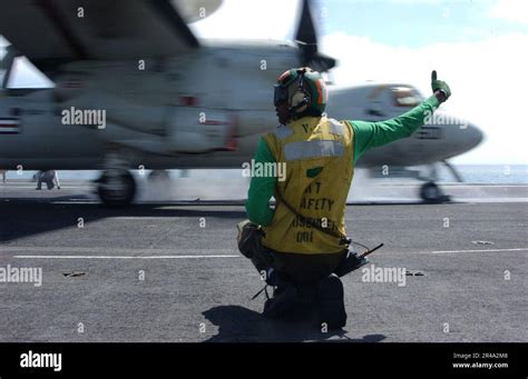 Us Navy A Catapult Safety Observer Clears An E2 C Hawkeye Assigned To The Golden Hawks Of