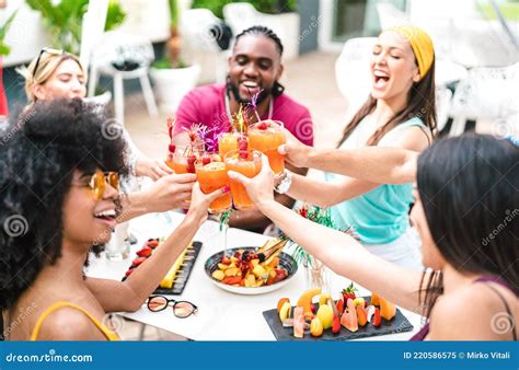 Multiracial Friends Toasting Sex On The Beach Fancy Cocktails Stock