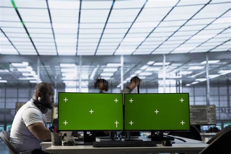green screen pc multi monitor setup in server hub used by team of