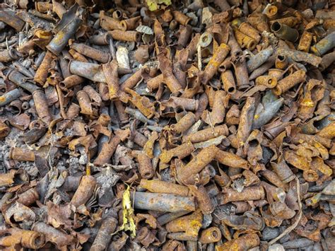 Premium Photo Burned Cartridges And Casings For Firearms That Exploded In An Ammunition Depot