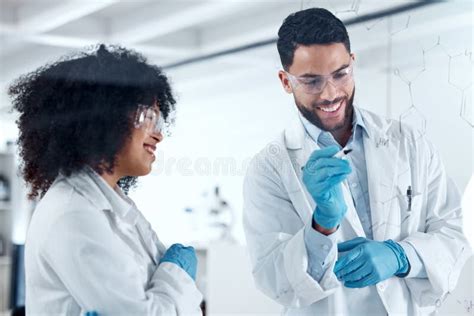 Two Young Science Experts Conducting A Research Experiment In The Lab Together Two Scientists
