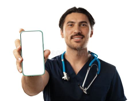 smiling asian doctor showing blank smartphone with white screen isolated on white stock image