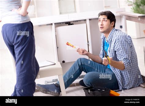 Husband Repairing Broken Table At Home Stock Photo Alamy