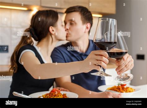 Romantic Dinner At Home Happy Couple Kissing Clinking Glasses And