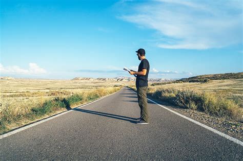 Man On The Road Looking A Map By Stocksy Contributor ACALU Studio Stocksy
