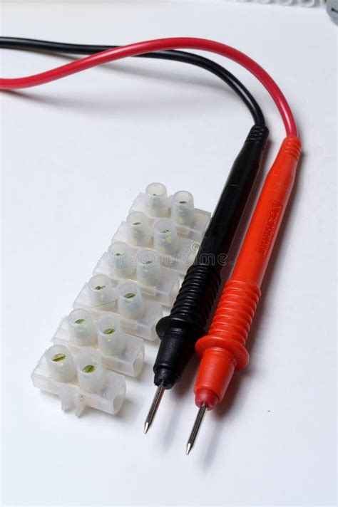 Multimeter Probes And Terminal Blocks Lie On A Light Background Close