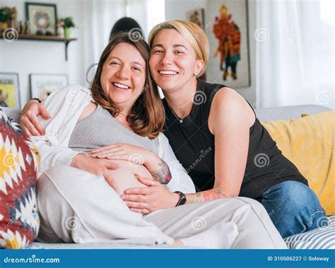 Happy Smiling Women Couple Waiting For Baby Same Sex Pregnant Marriage Couple On Home Sofa