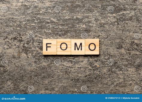 fomo word written on wood block fomo text on table concept stock