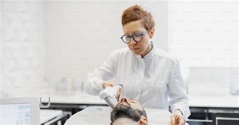 미용사와 함께 미용 클리닉에서 초음파 얼굴 리프팅 절차에 잘 생긴 남자 안티 에이지 및 웰빙 개념 사진 Unsplash의