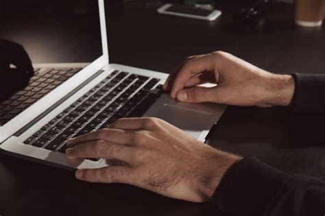 Premium Photo Man Hacking Server In Dark Room