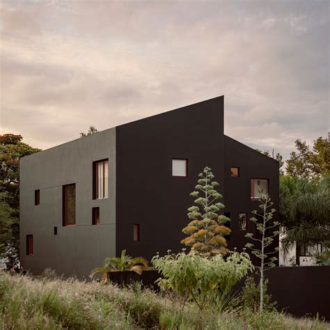 House in Normandy with blackened timber walls by Beckmann N Thépé