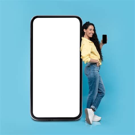 Premium Photo Happy Young Woman Standing Near Big Cellphone With