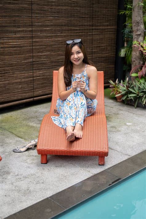A Beautiful Asian Woman Is Sipping Vodka Martini Drink On A Lounge