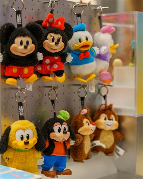 Plush Disney Character Keychains Displayed On A Rack Photo Free