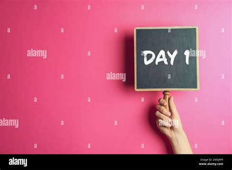 Starting New Life Woman Holding Blackboard With Text Day 1 On Pink