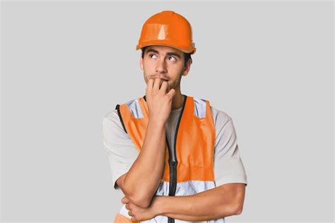 Premium Photo Young Hispanic Worker In Safety Gear Relaxed Thinking