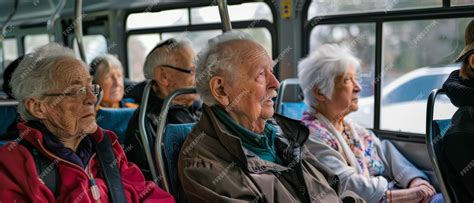 A Group Of Elderly People Sitting On A Bus Engaged In Conversations And Enjoying A Communal