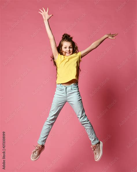 Smiling Young Girl Or Teen Girl In Jeans And Yellow T Shirt Have Fun