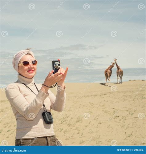 Woman Is Standing Next To A Giraffe And Photographs Stock Image Image Of Giraffes Screen