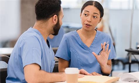Assertiveness In Nursing A Nurse Gestures During A Conversation With A