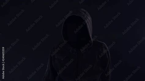 hooded computer hacker click virtual screen low key slow motion