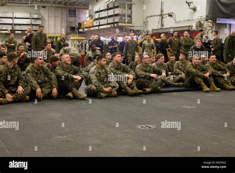 Us Marines And Sailors Wait For A Projector And Screen To Be Set Up In Order To Watch The