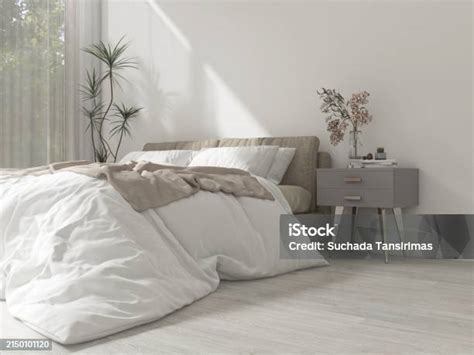 베이지색 침대 회색 사이드 테이블 얇은 커튼이 있는 창문에서 햇빛이 들어오는 드라세나 나무가 있는 현대적이고 미니멀한 흰색 침실 침실에 대한 스톡 사진 및 기타 이미지