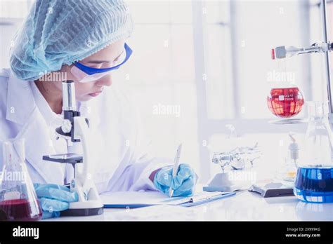 Female Scientist Look At Microscope Science Test Tube Analyse Scientific Sample In Laboratory