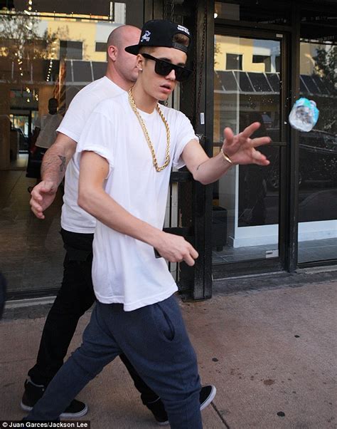 Justin Bieber Checks Out His Barely There Biceps While Shopping In