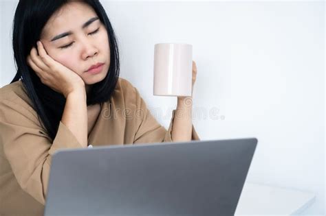 Tired Asian Woman Asleep At Office Desk Hand Holding Cup Of Coffee Stock Image Image Of