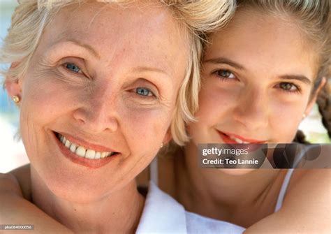 Young Girl Hugging Senior Woman From Behind Close Up Portrait High Res